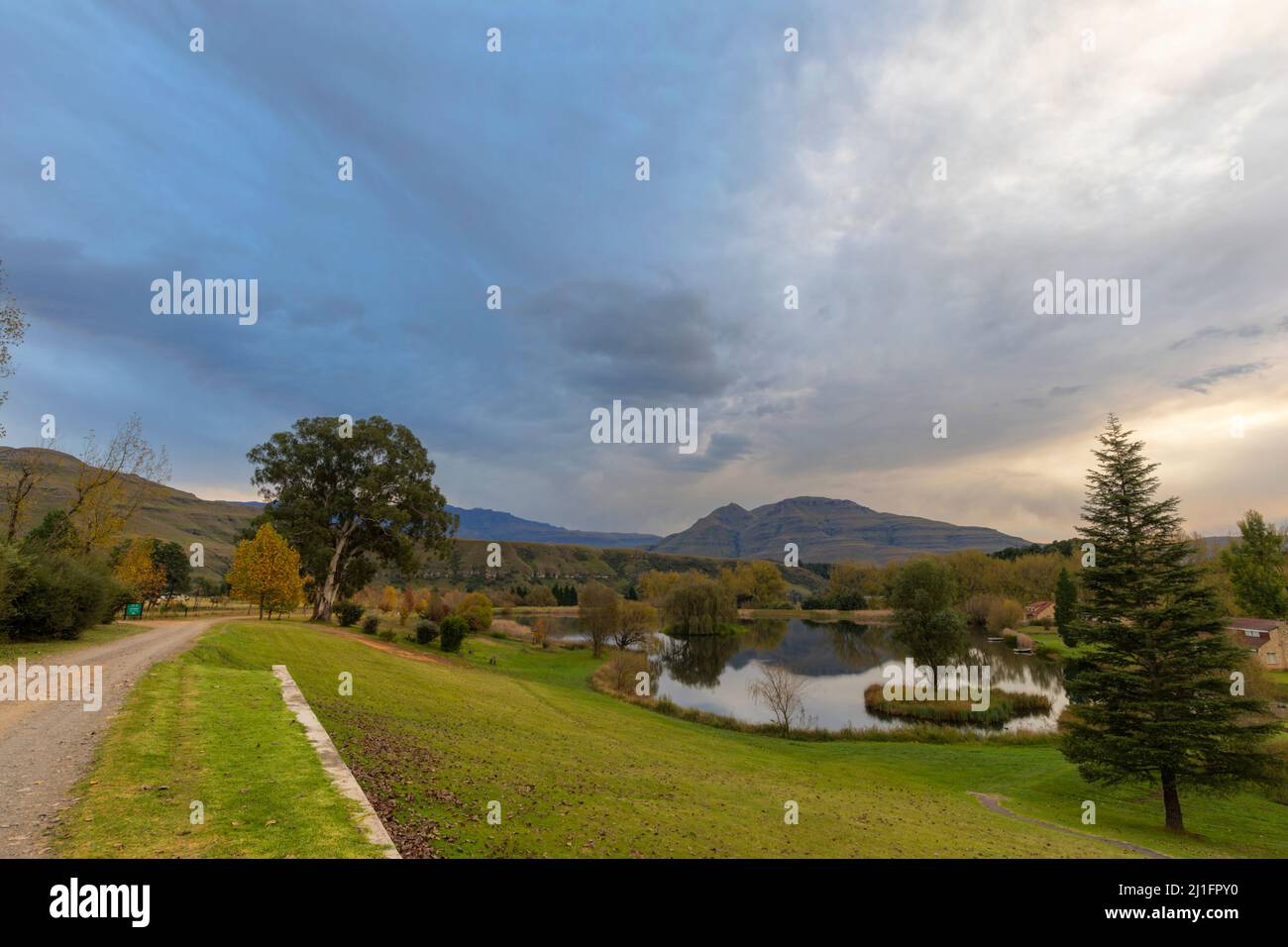 Dark clouds at sunrise at Lake Naverone Drakensberg South Africa Stock ...