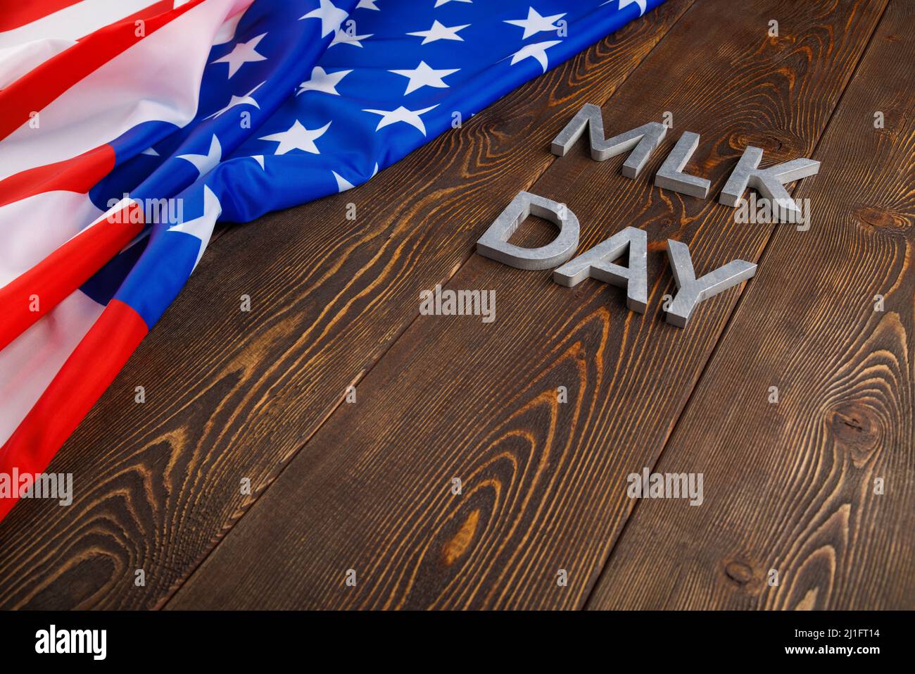 the word MLK day laid with silver metal letters on wooden surface with ...