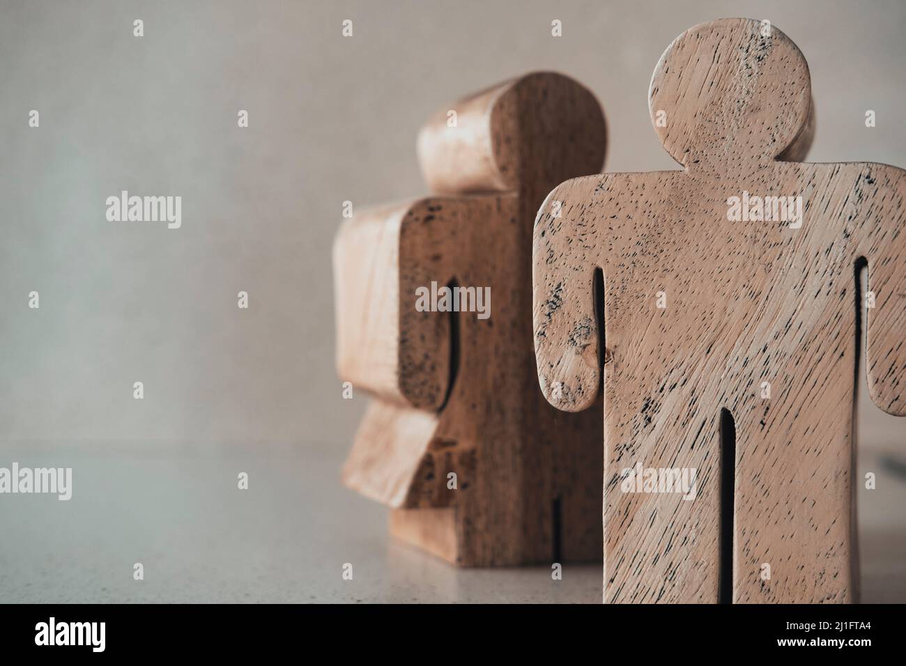 figures of man and woman made with wood on a neutral background Stock ...