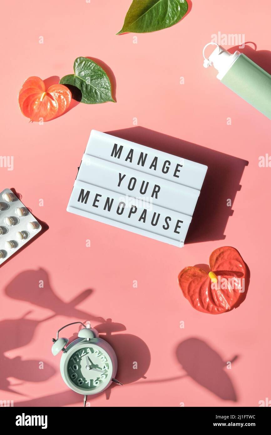 Text Manage your menopause. Pink frame in hand. Menopause, hormone ...