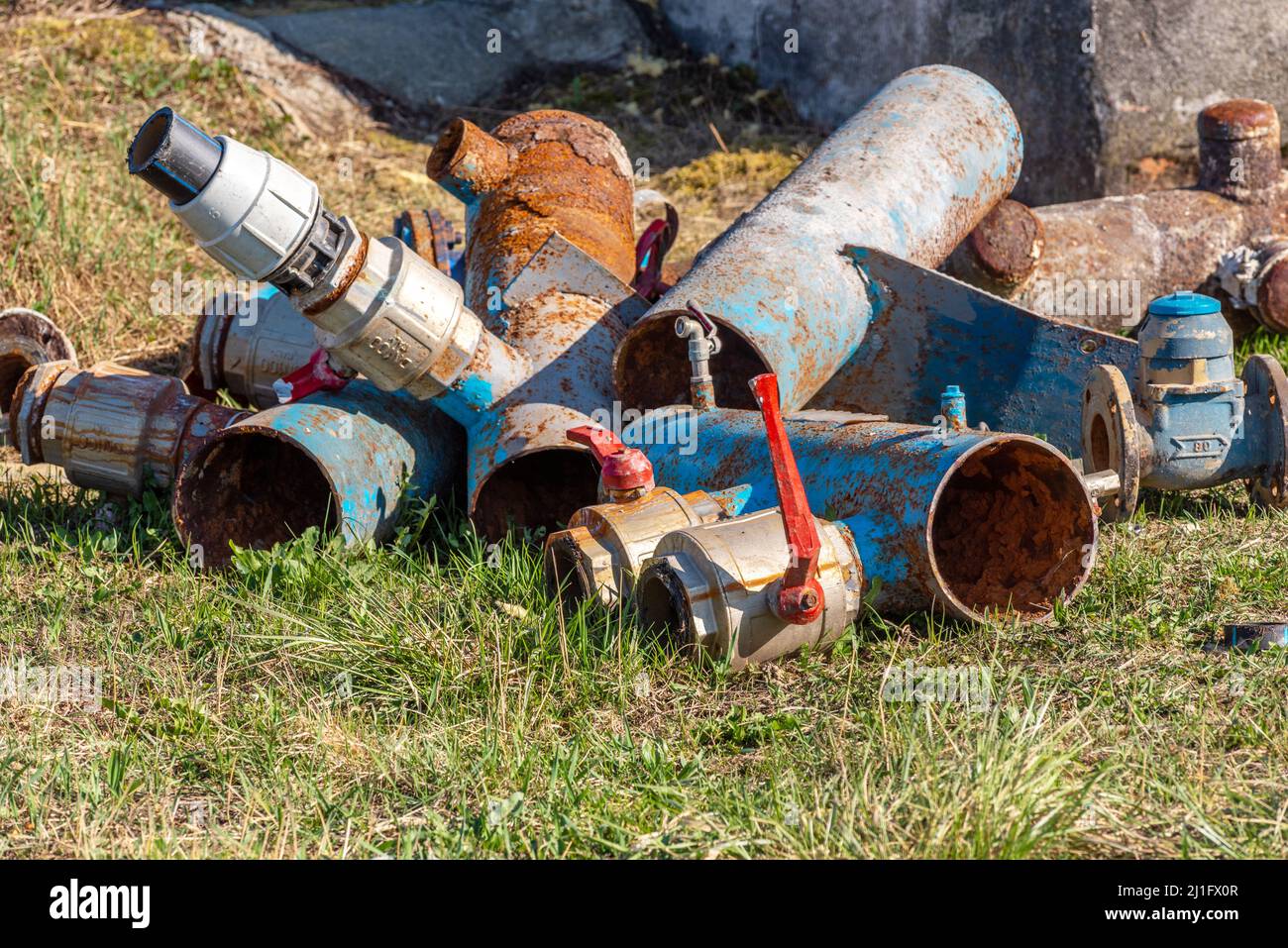 Scrap metal, pile of old cut and rusted plumbing pipes with big broken ...