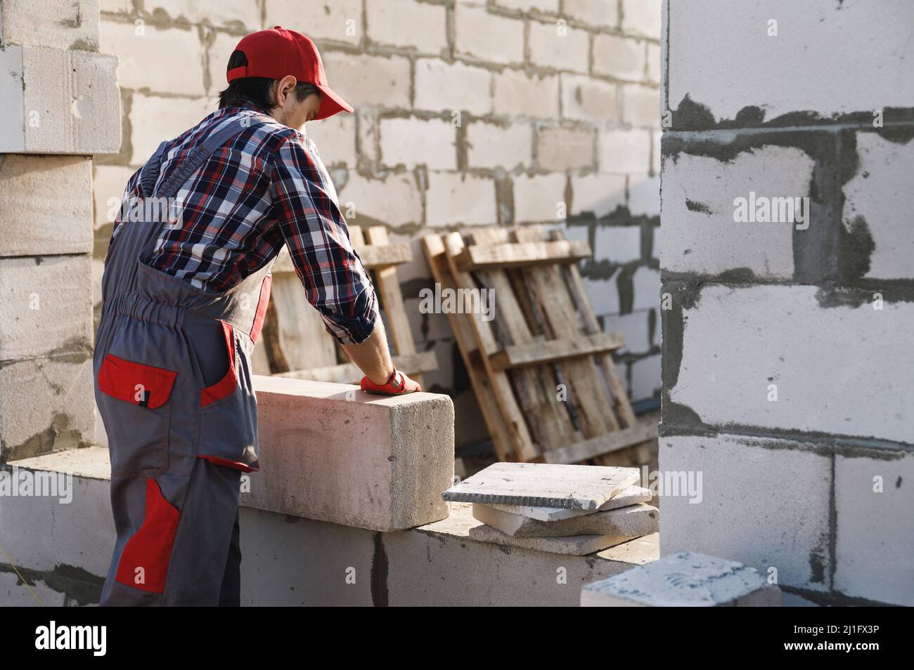 Bricklayer is working at the construction site Stock Photo - Alamy