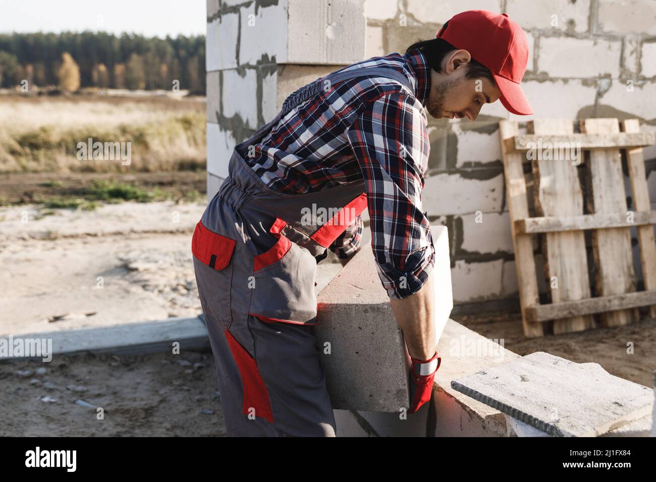 Bricklayer is working at the construction site Stock Photo - Alamy