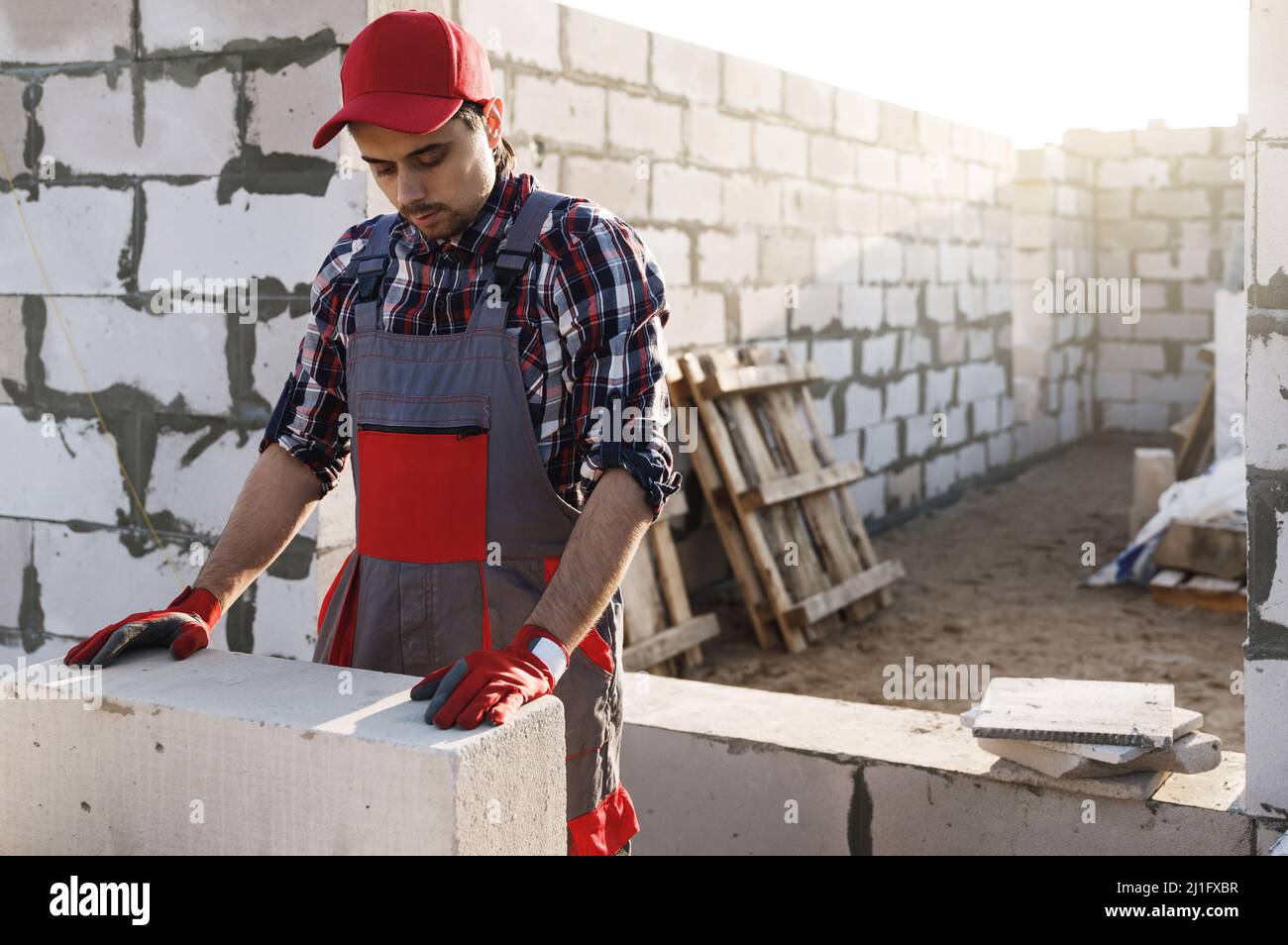 Bricklayer is working at the construction site Stock Photo - Alamy