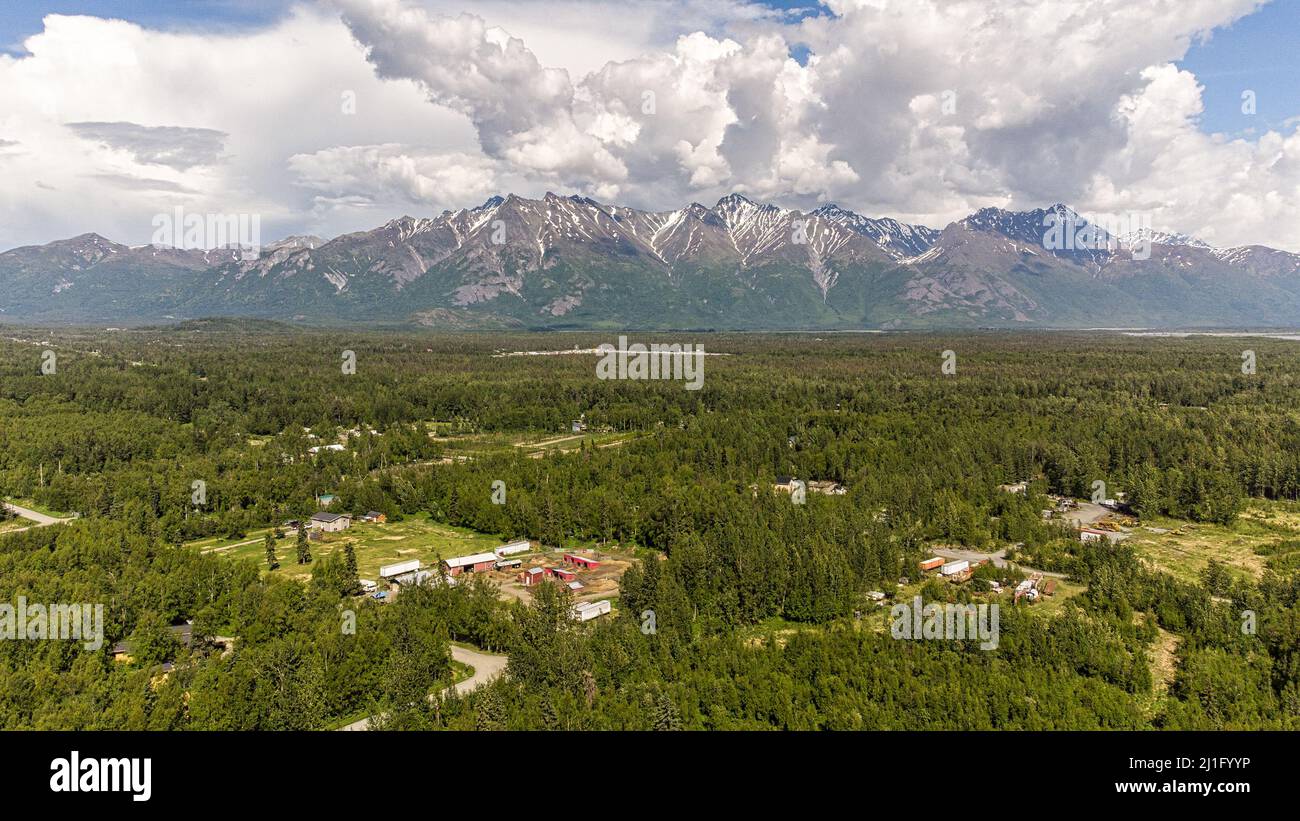 An aerial view of green forests near the mountains in Palmer, Alaska ...