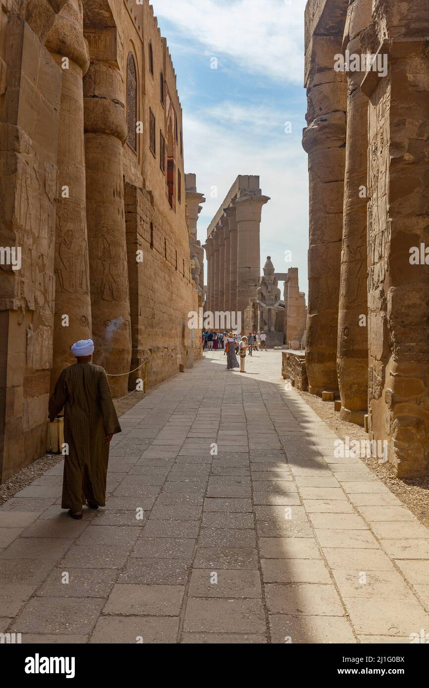 Local man walking through the first Pylon of Luxor Temple Stock Photo ...