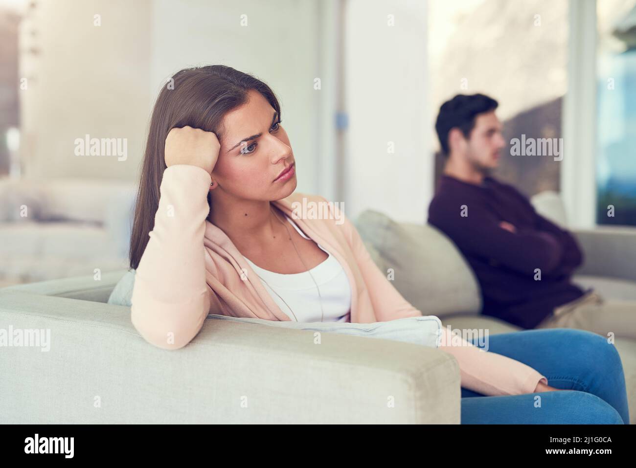 Becoming disconnected. Portrait of a young woman giving her husband the ...