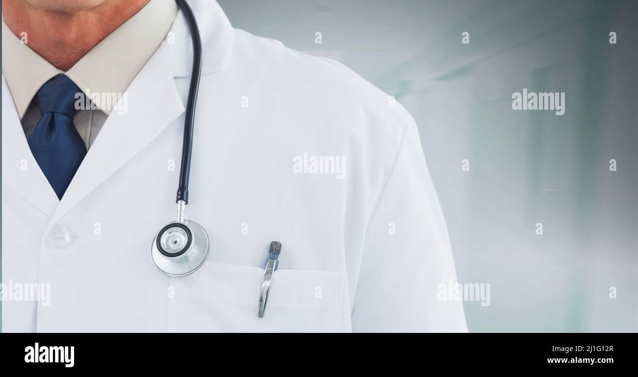 Mid section of caucasian male doctor against hospital in background ...