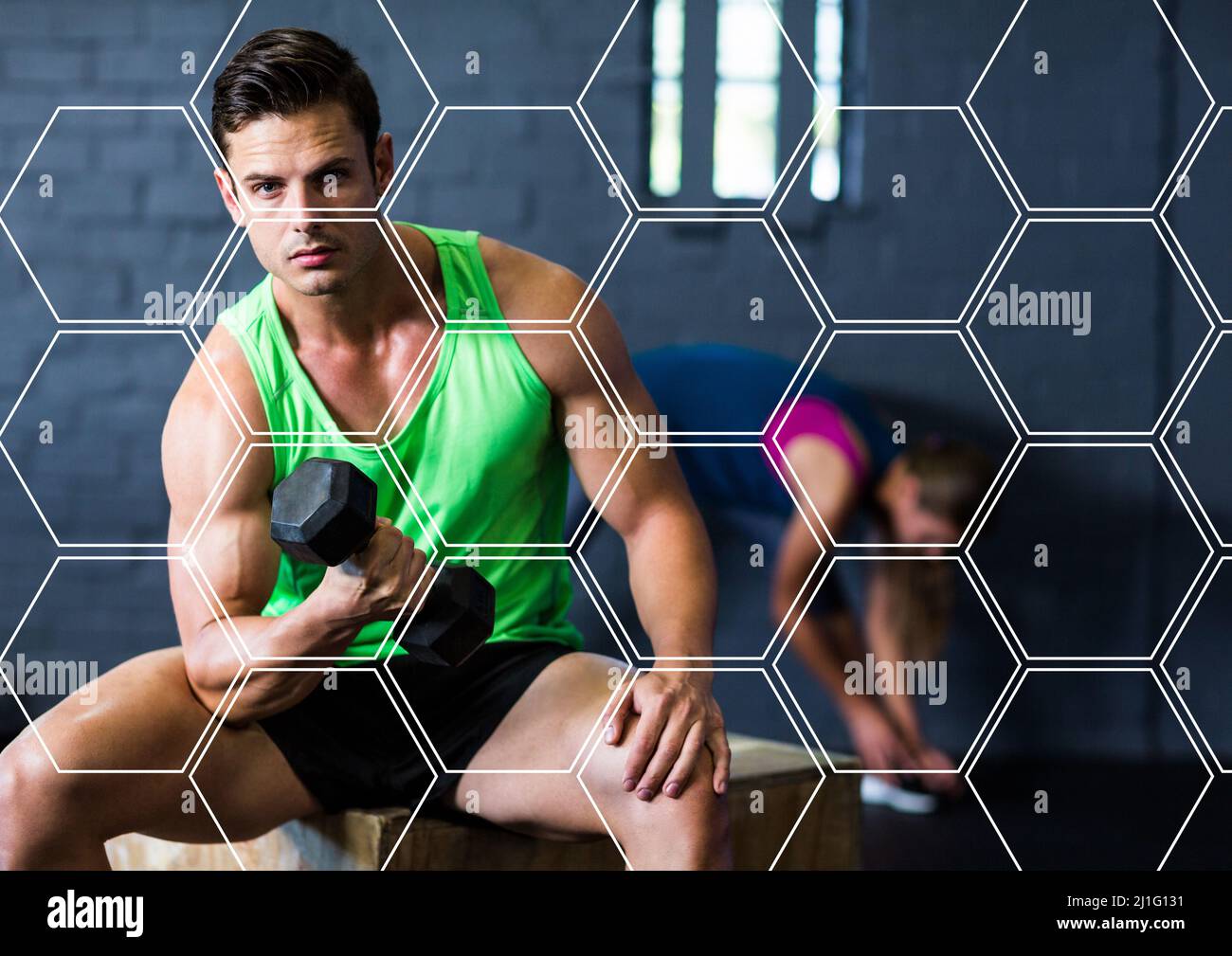 Hexagonal shapes pattern against caucasian fit man performing exercise ...