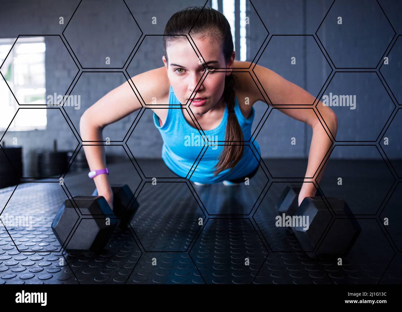 Hexagonal shapes pattern against caucasian fit woman performing push up ...
