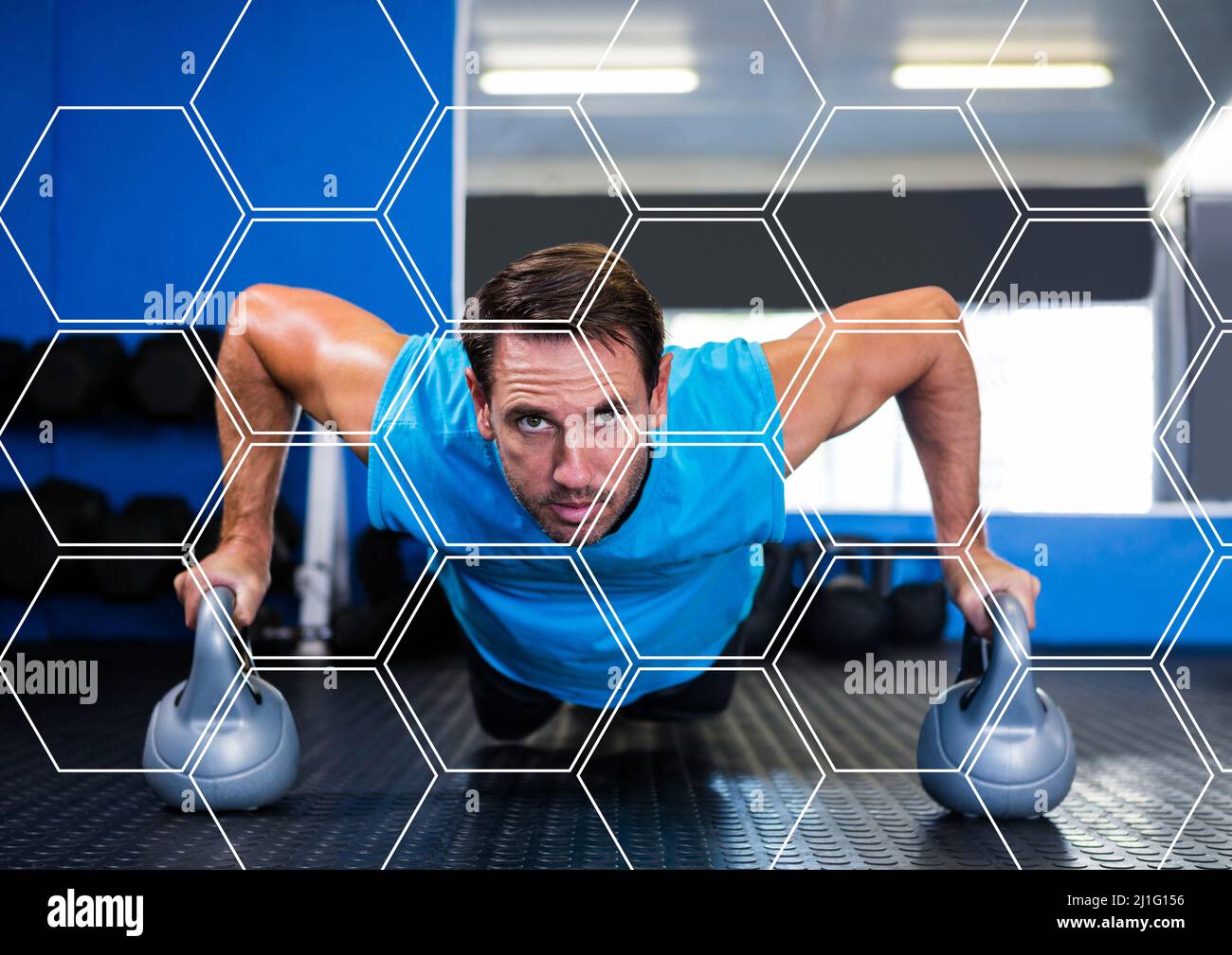 Hexagonal shapes pattern design against caucasian fit man performing ...