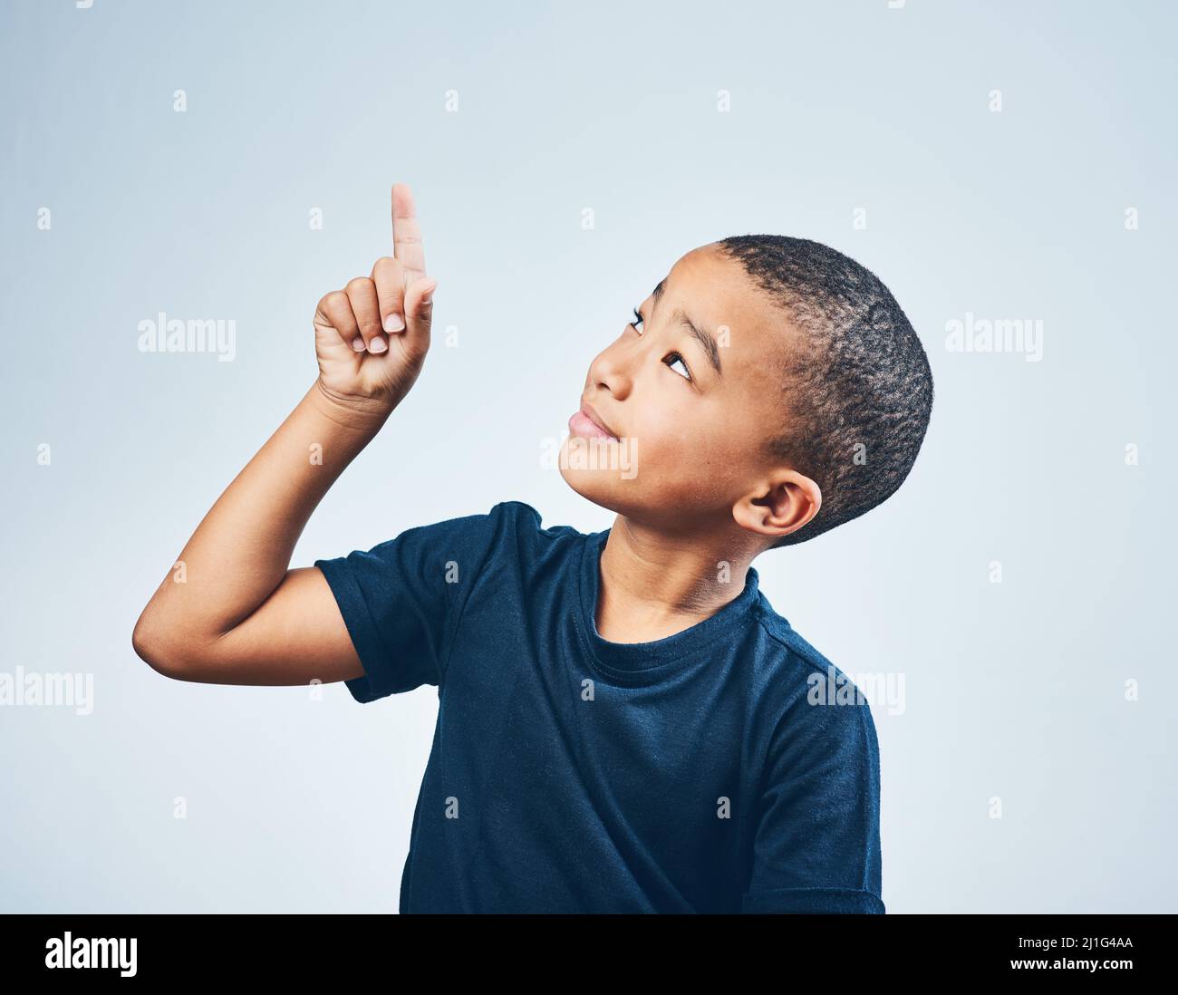 You discover something new everyday. Studio shot of a cute little boy ...