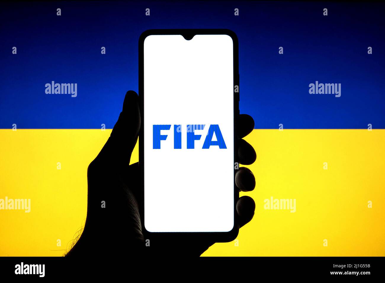 In this photo illustration a FIFA logo seen displayed on a smartphone ...