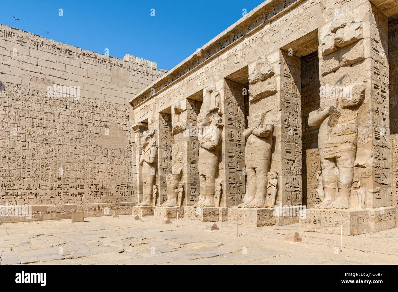 Statues of Ramesses III as Osiris in the first courtyard of Medinet ...