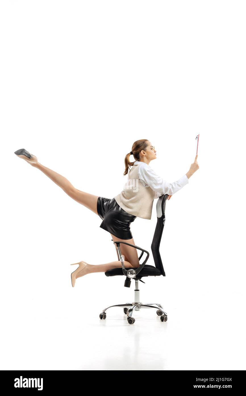 Portrait of young flexible woman in business style clothes with folder ...