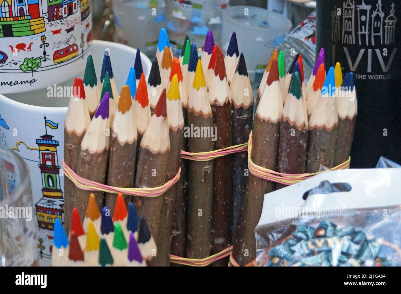 Decorative multi-colored pencils made of tree branches on the counter ...