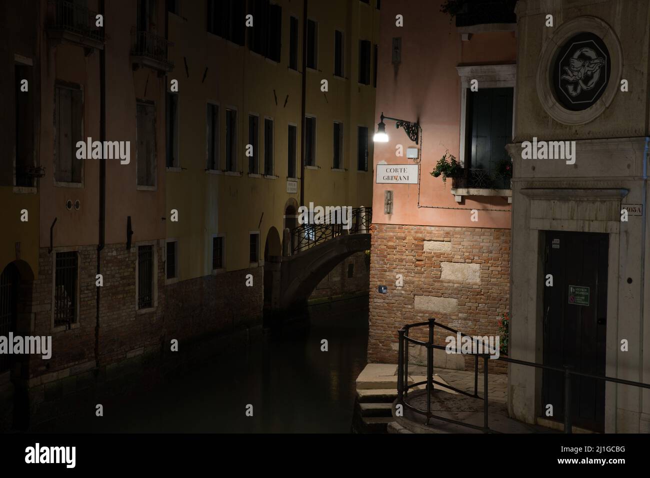 A beautiful shot of an arch bridge over a narrow canal between ...