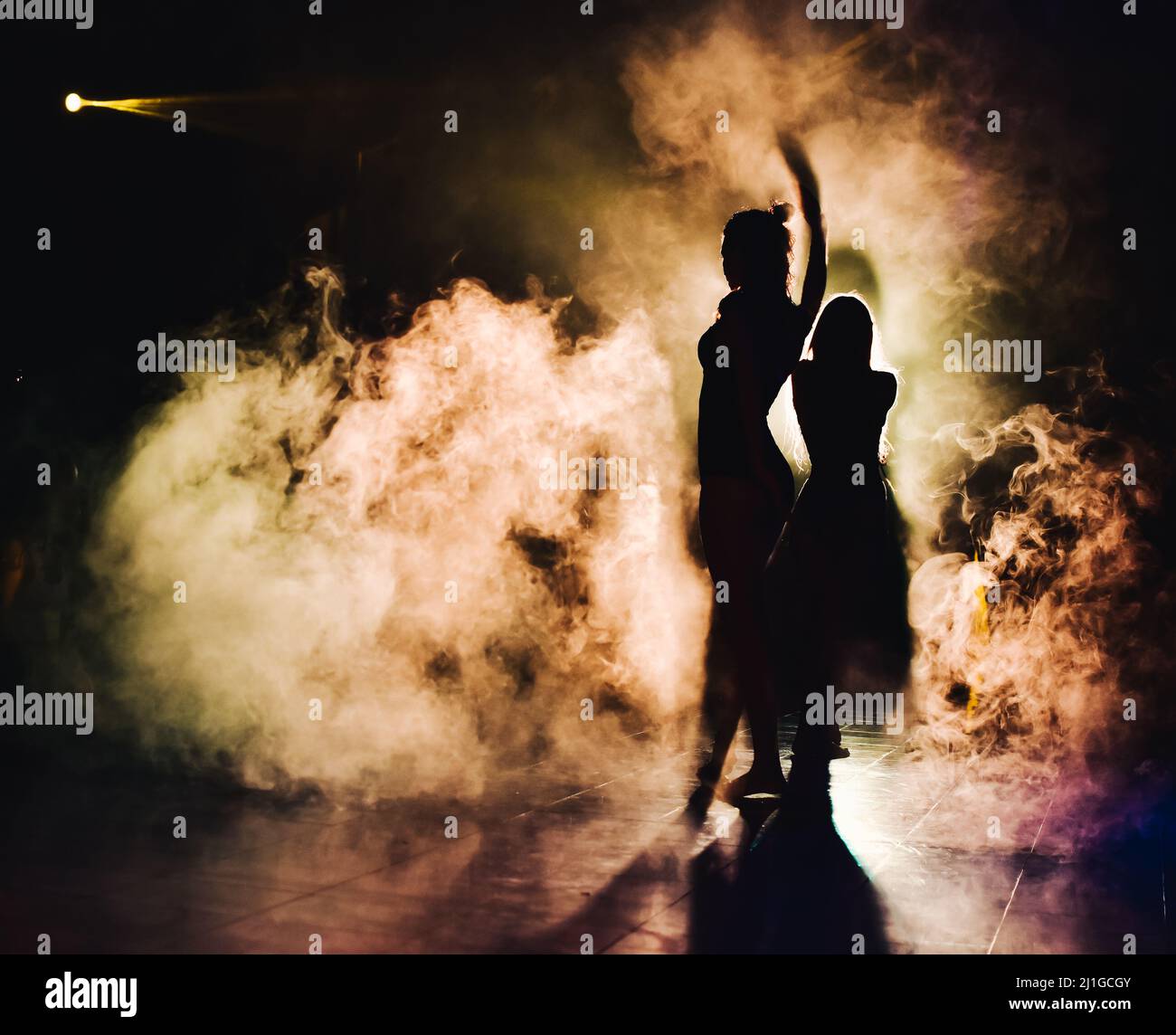silhouette of a woman dancing between lights and smoke Stock Photo - Alamy