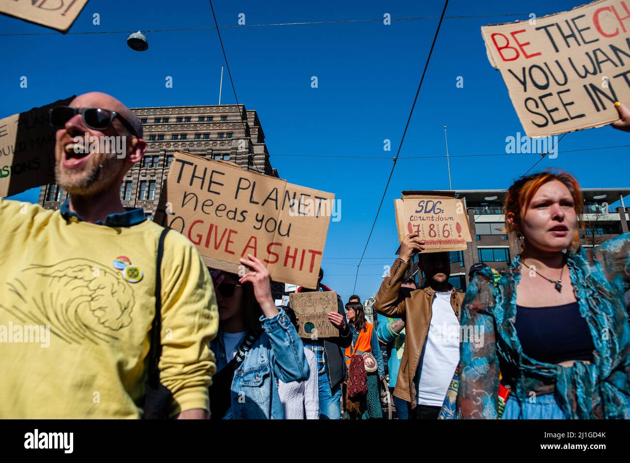 A group of protesters shout slogans against climate change while ...