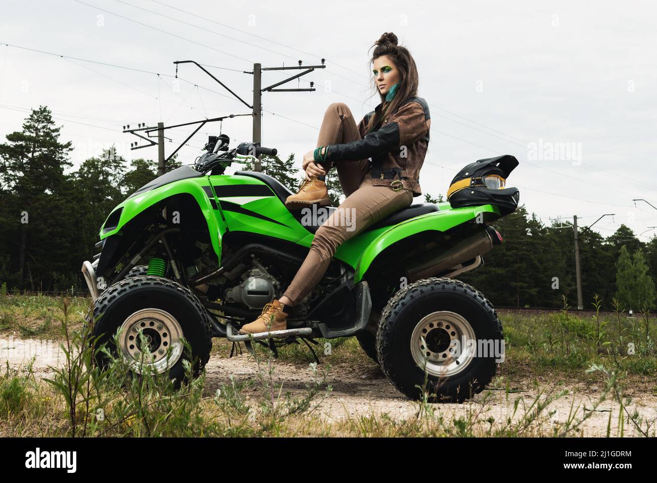 Stylish and beautiful woman and the ATV Stock Photo - Alamy