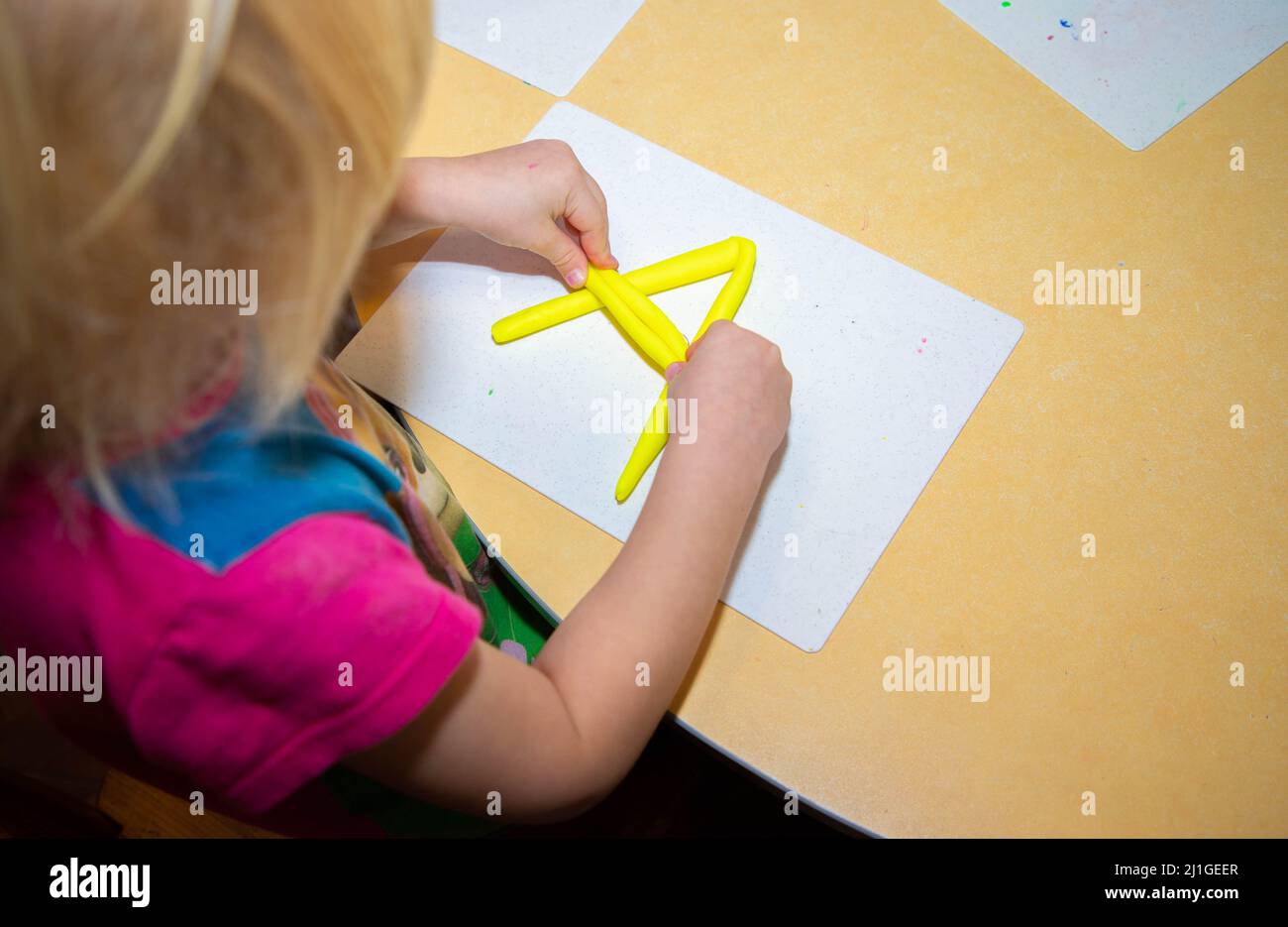 The hands of a child of European appearance write and circle the ...