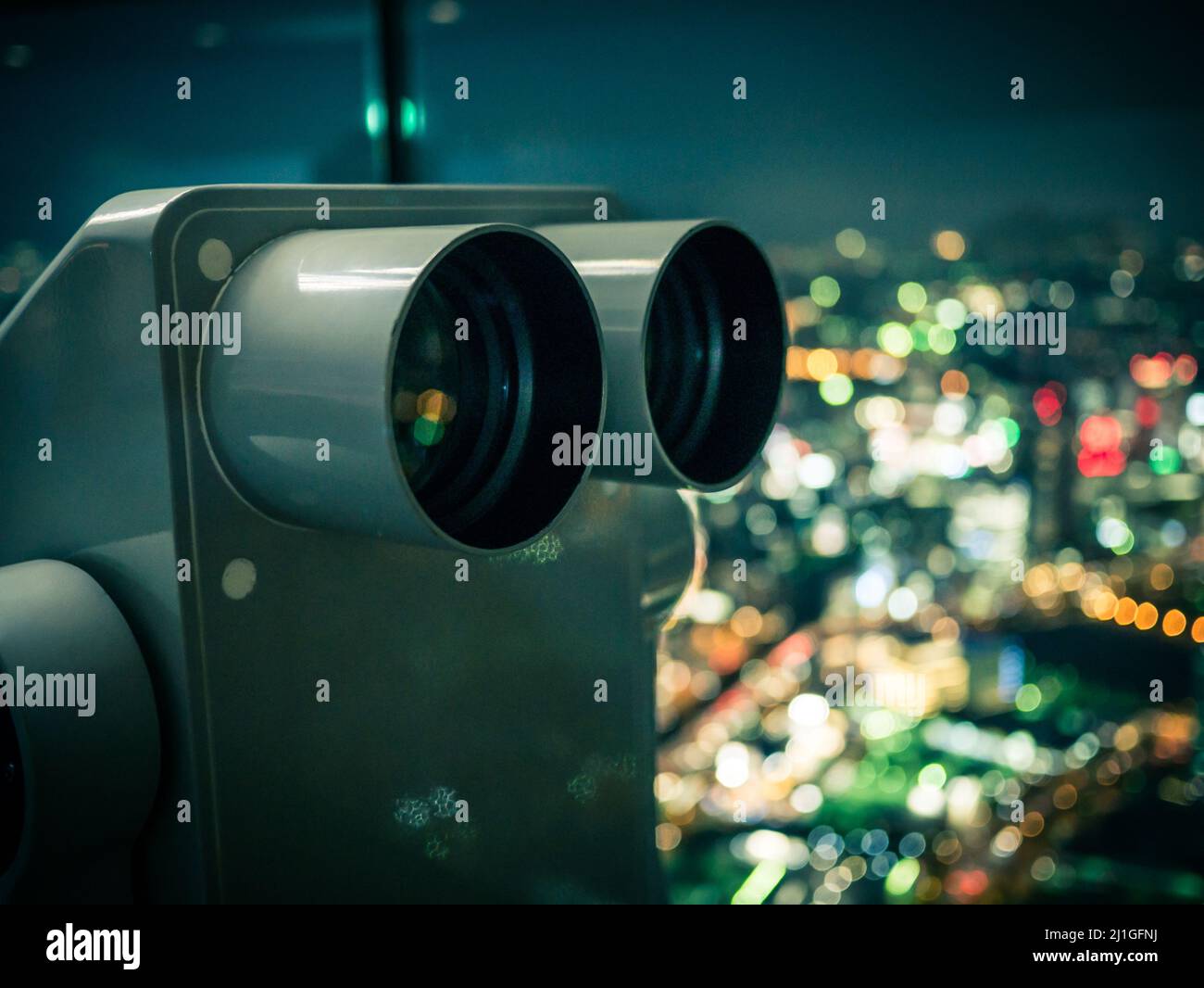 Viewpoint binoculars with the blurred background of colorful urbanized ...