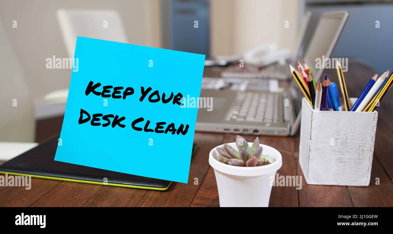 Image of keep your desk clean note over office items and laptops on ...