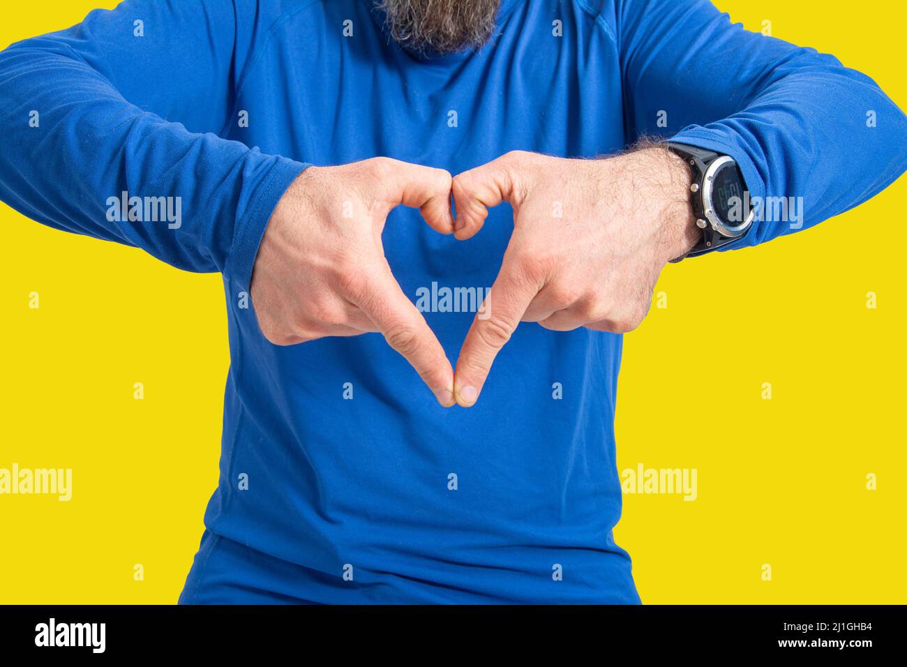 Young man making heart shape with hands Stock Photo - Alamy