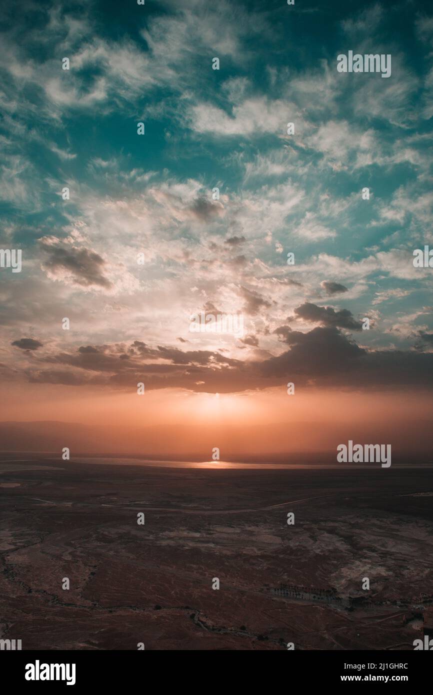 A beautiful sunset scene of clay beach with dramatic colorful sky on ...