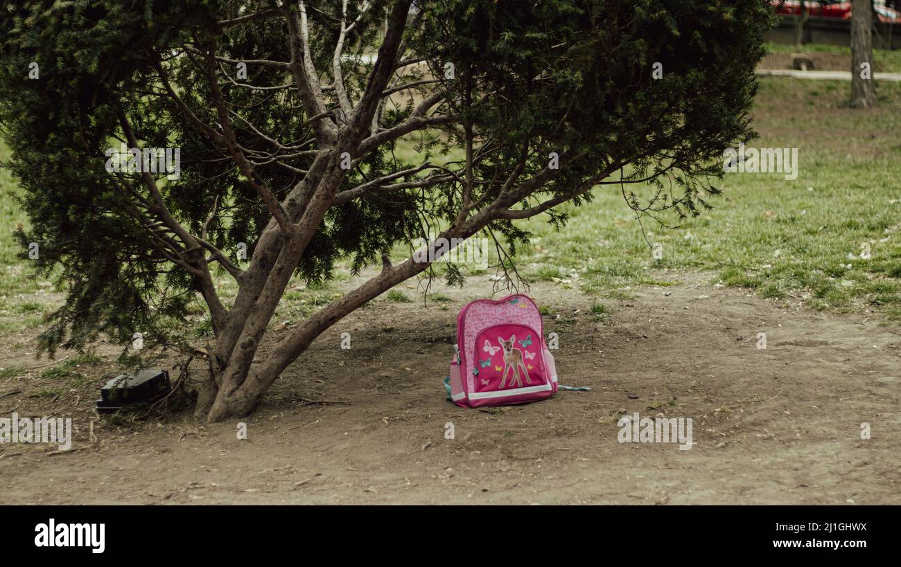Preschool bag forgotten under a tree Stock Photo - Alamy