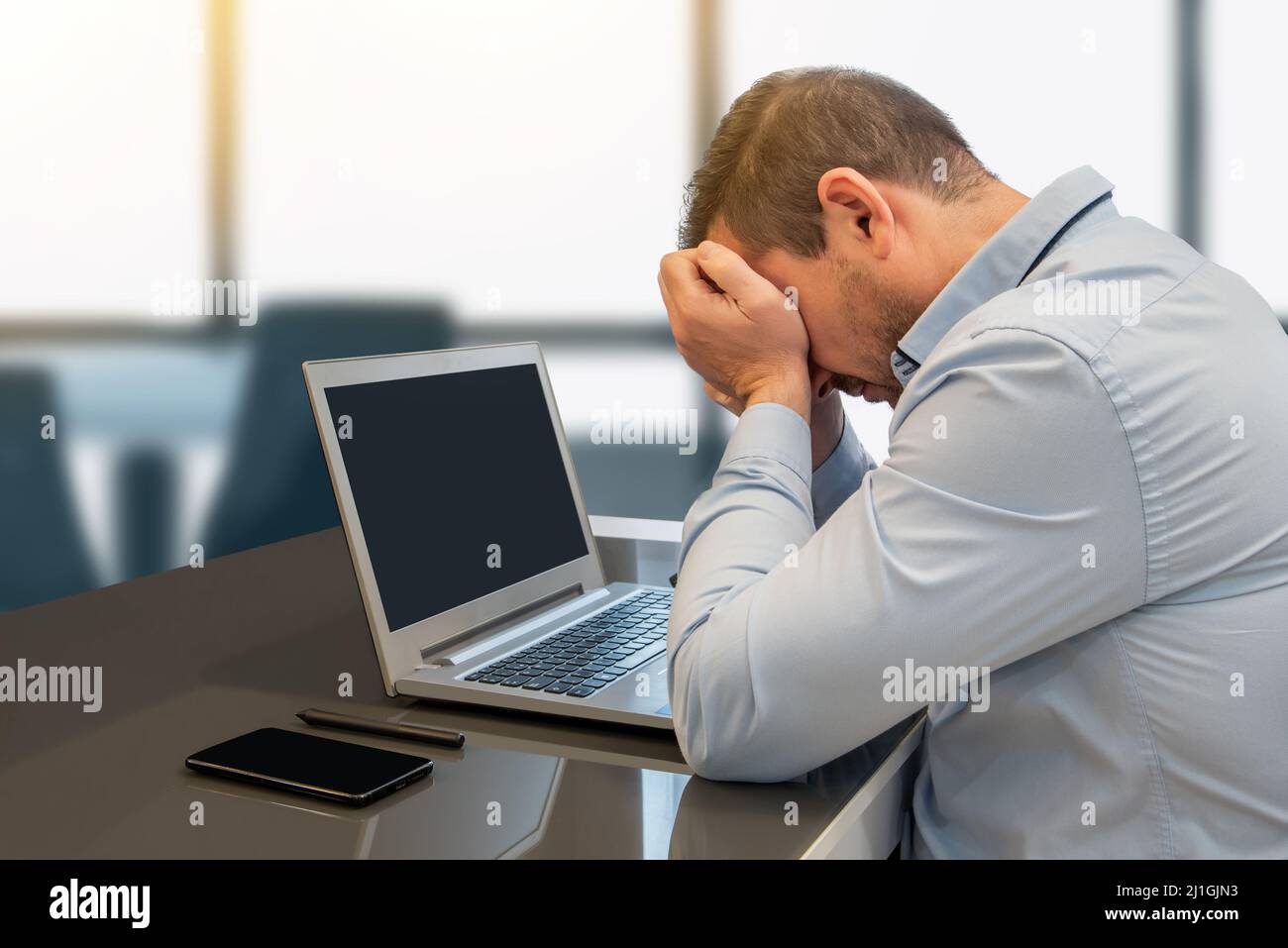 Businessman overwhelmed by work. Frustration and despair in the office ...