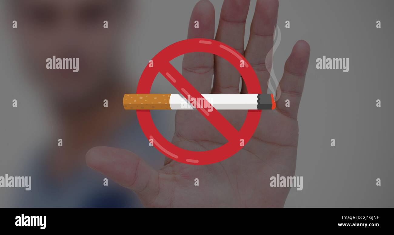 Digital composite image of no smoking symbol over caucasian man's palm ...
