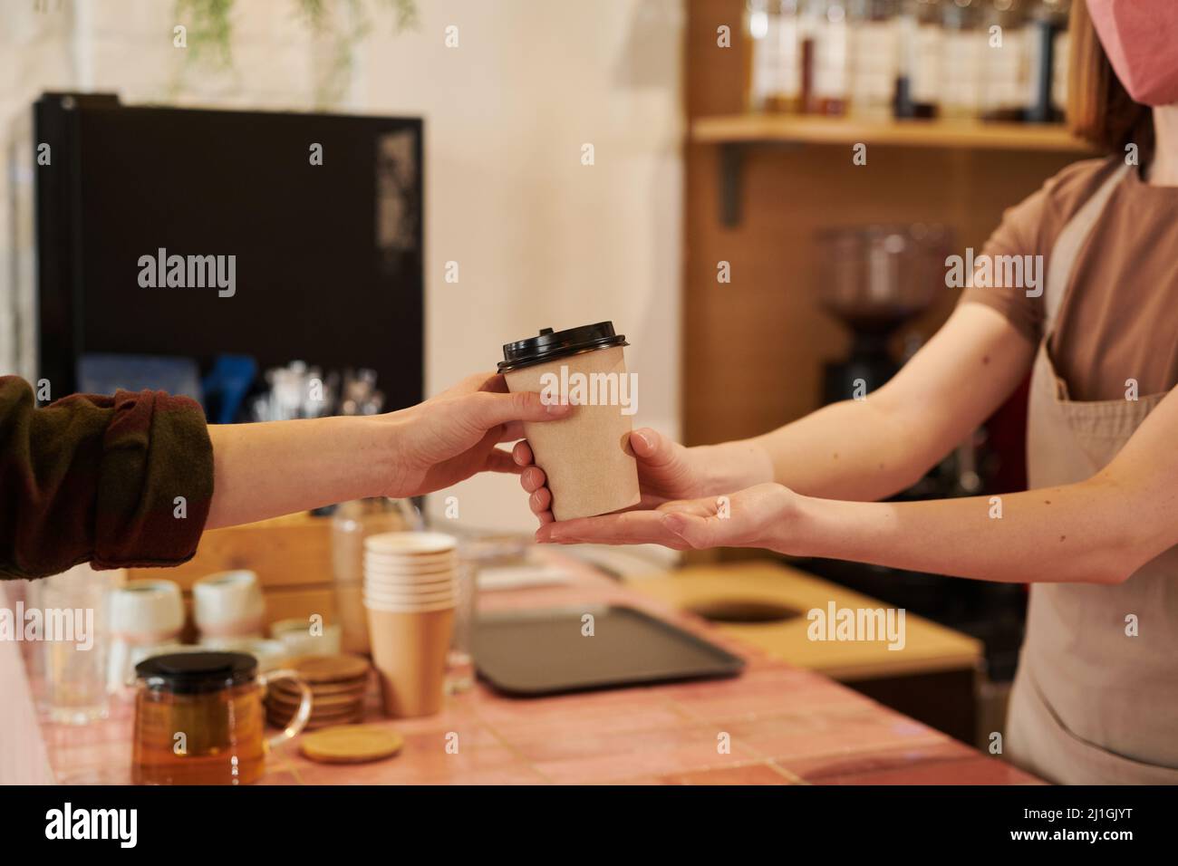 Medium section side view shot of unrecognizable female barista wearing ...
