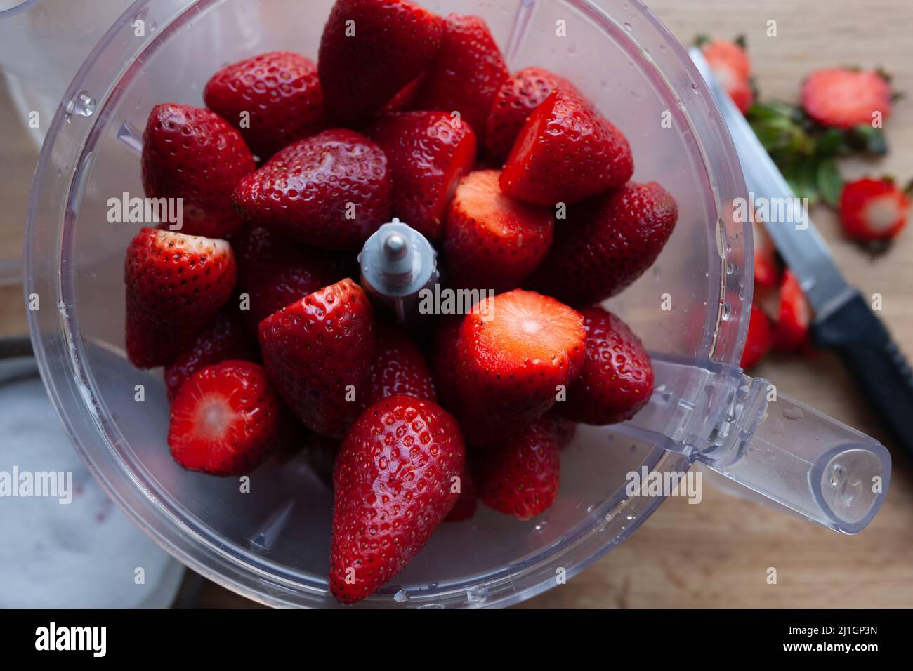 Fresh, ripe strawberries in blender container, washed and ready to be ...