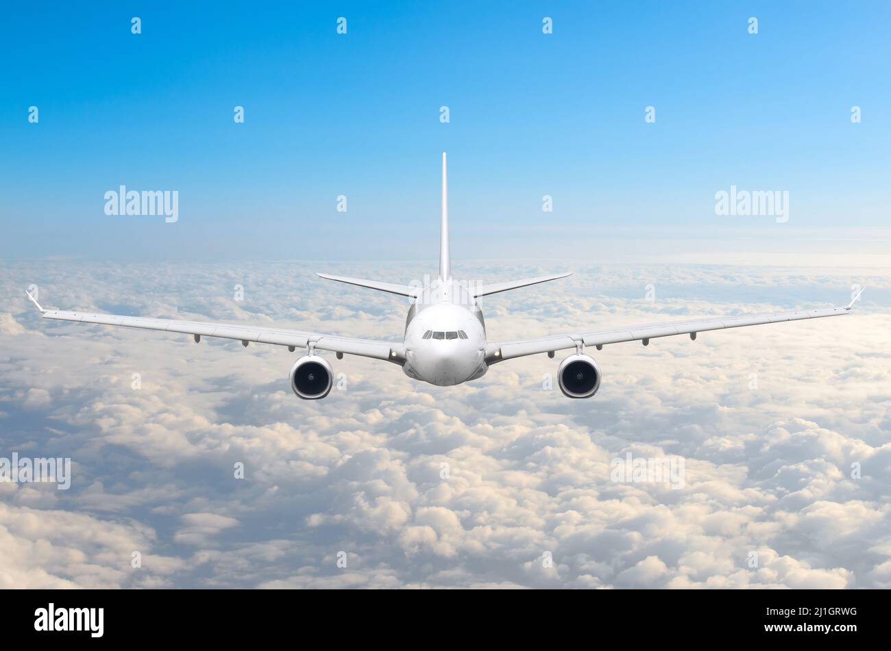Passenger airplane flying at flight level high in the sky above the ...