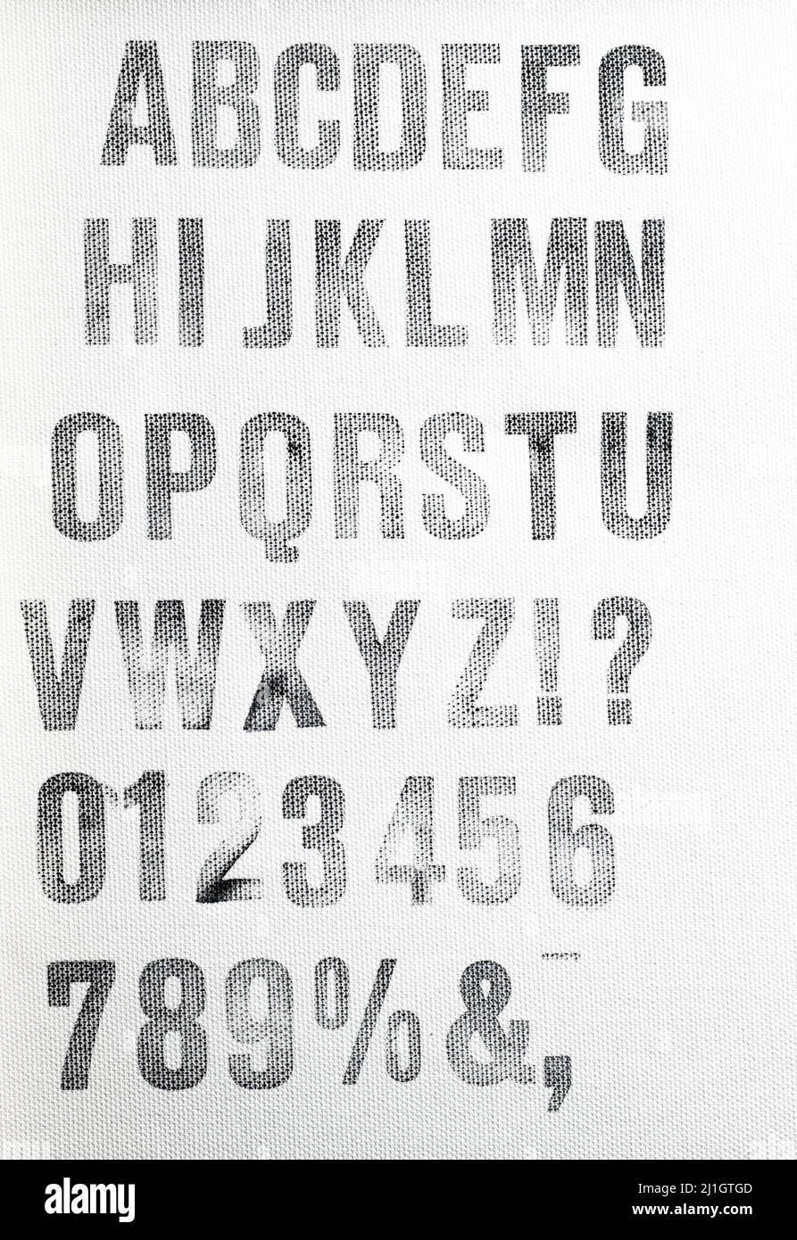 alphabet uppercase characters stamped with black ink on white canvas ...
