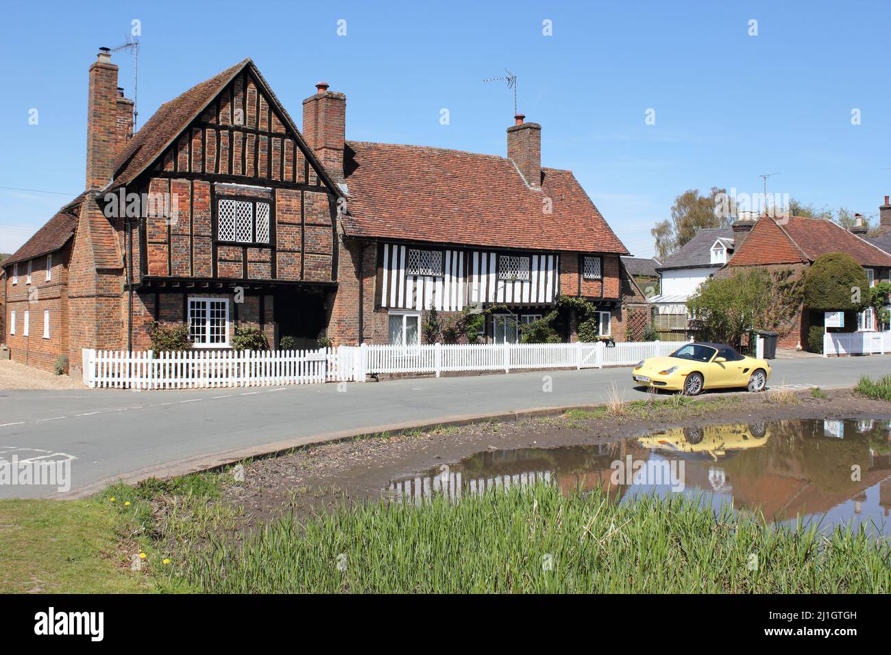 Pond & The Old Manor House with parked yellow Sportscar, Aldbury ...