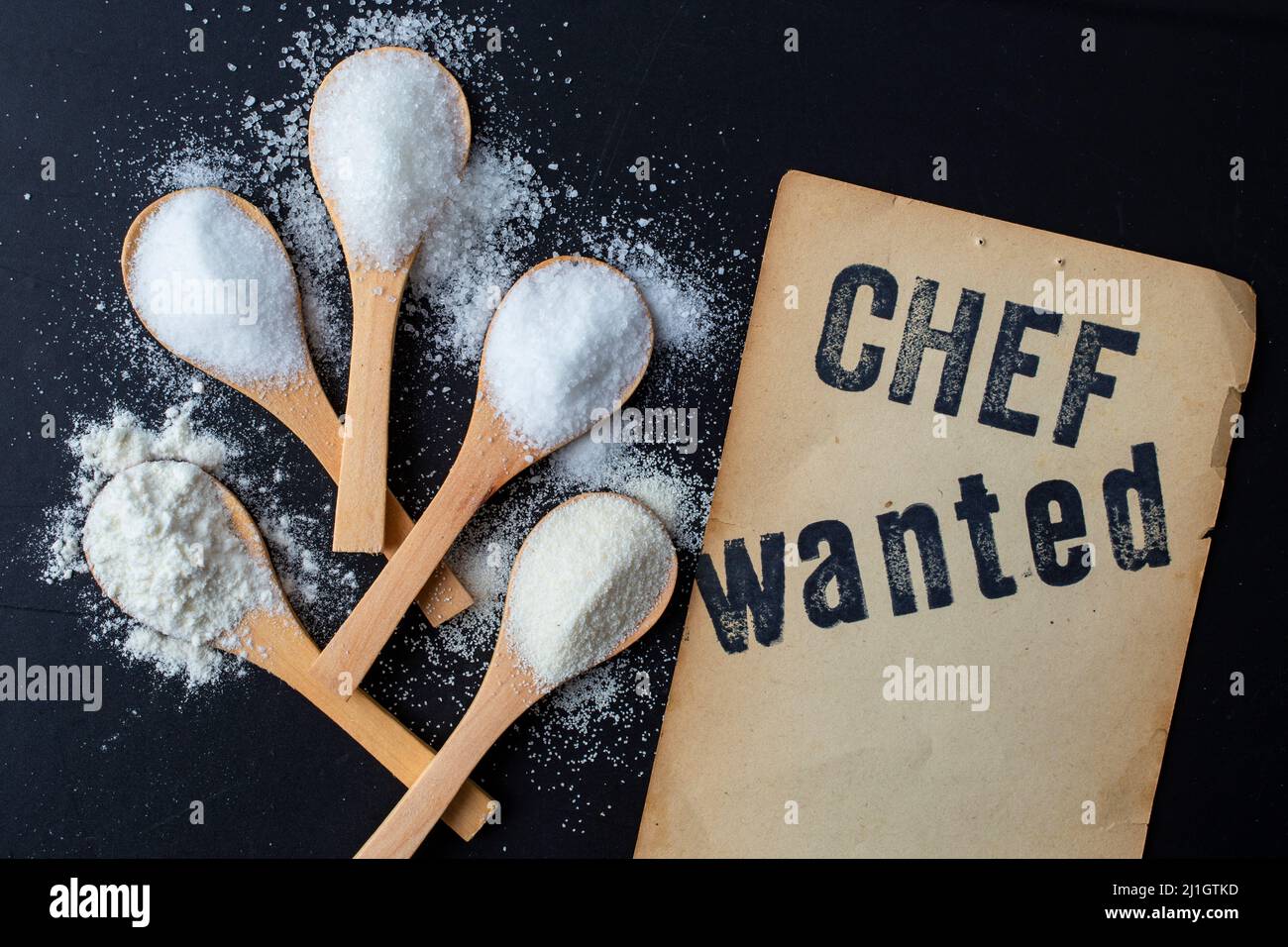 Chef wanted, written on vintage yellowed paper, next to 5 bamboo wooden ...