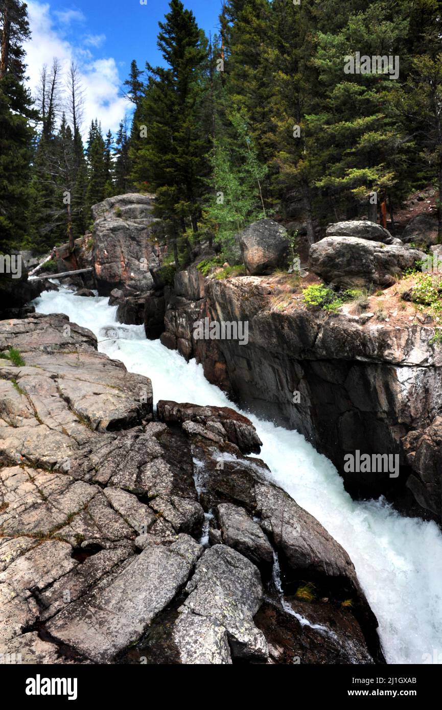 Splashing water slaps against the granite walls of Lake Creek Falls on ...