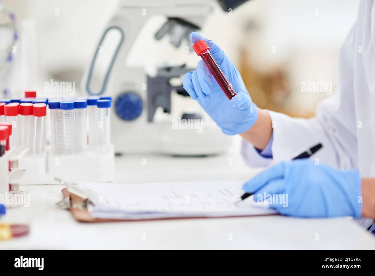 Observing facts and recording findings. Closeup shot of a scientist ...