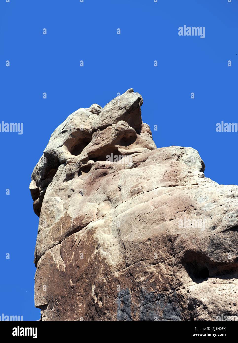 Boulder formation looms against a blue sky in the Garden of the Gods on ...