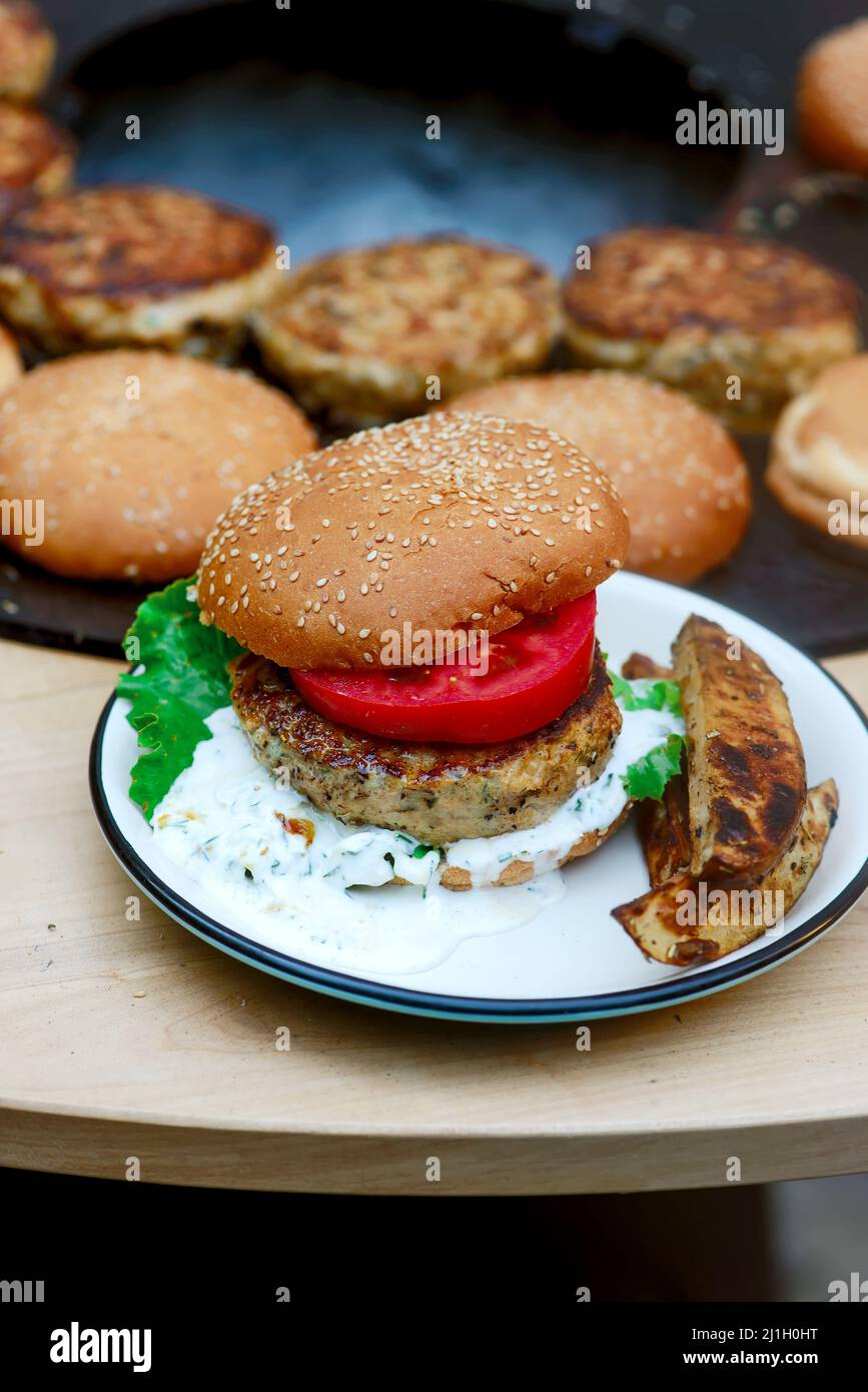 Chicken burgers cooking on an outdoor grill .selective focus Stock ...