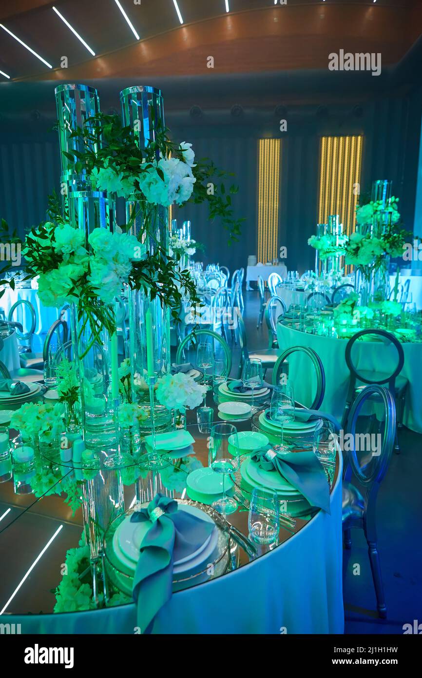 Table setup in blue light. Ready to event Stock Photo - Alamy