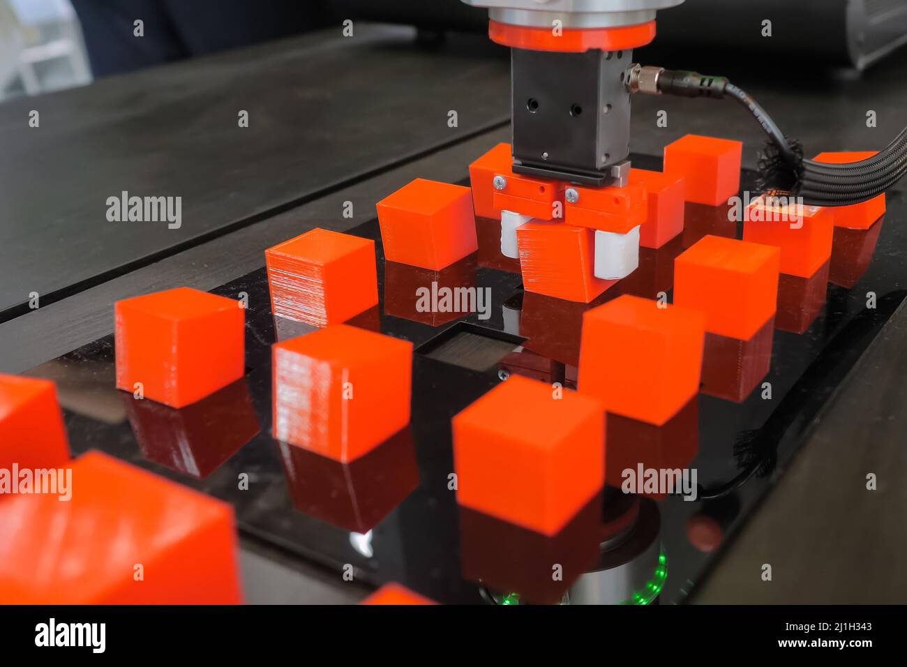 Pick and place robotic arm manipulator moving red toy blocks at robot exhibition Stock Photo - Alamy