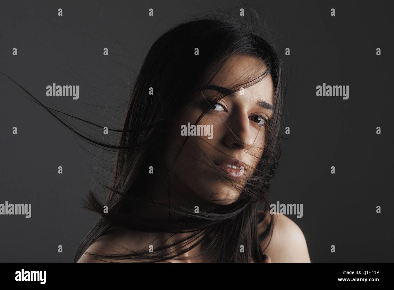 beauty fashion studio portrait of a beautiful young girl with windy ...