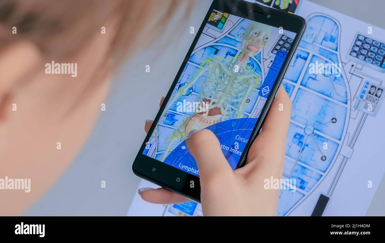 Woman using smartphone with augmented reality app: 3d model of human ...