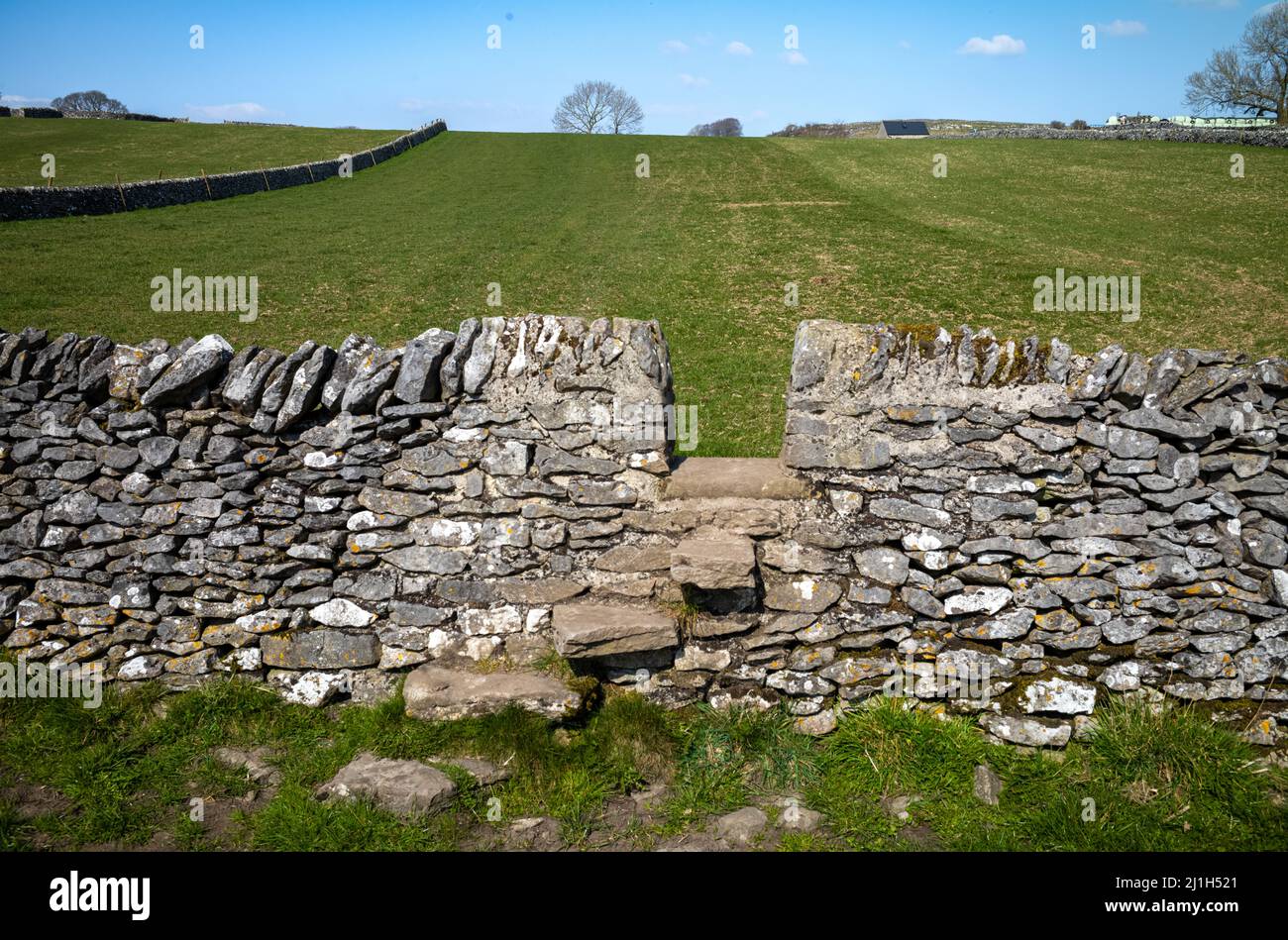 An traditional stile cuts through an ancient dry stone wall near Litton ...