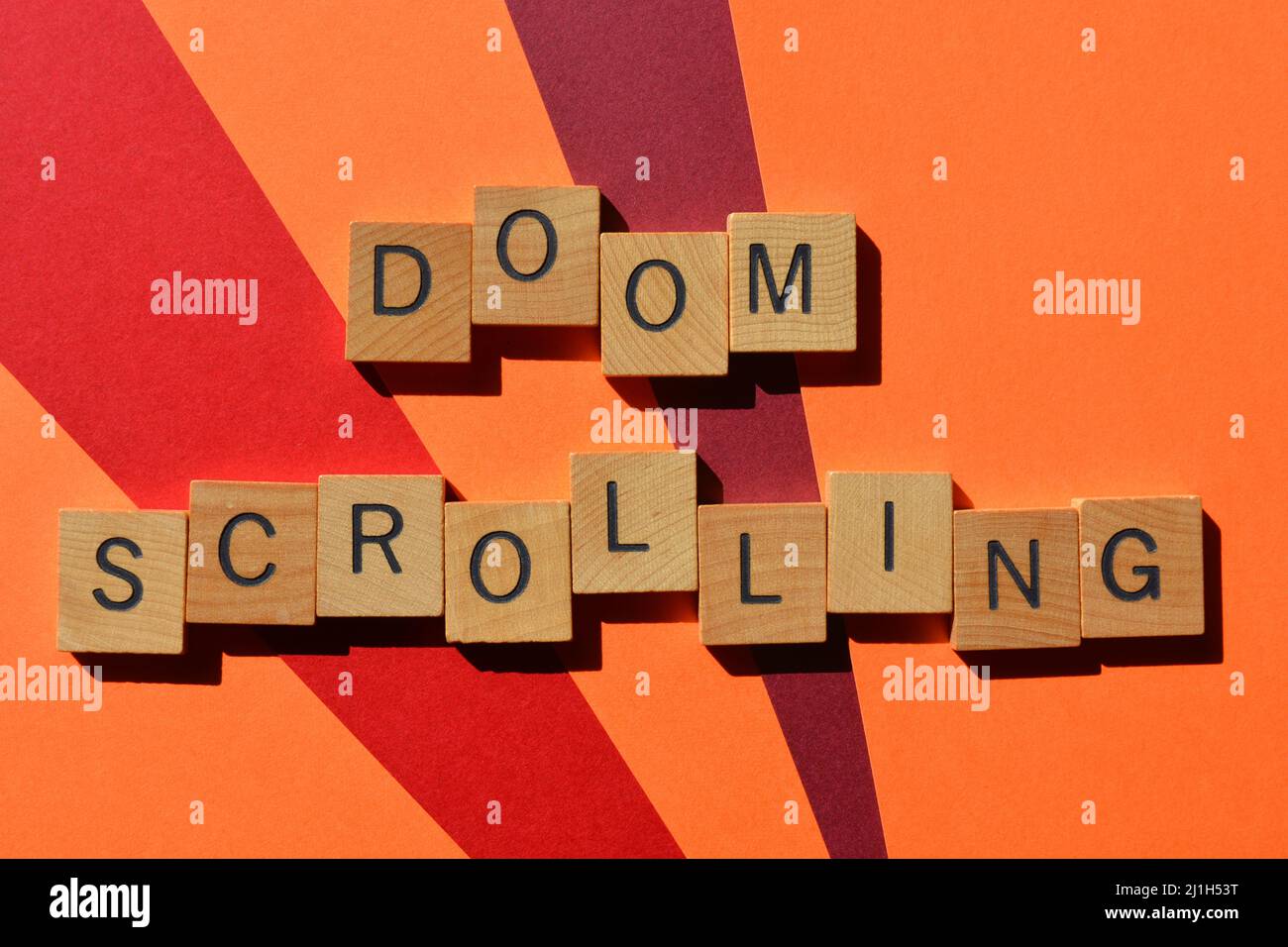 Doom Scrolling, words in wooden alphabet letters isolated on red and ...