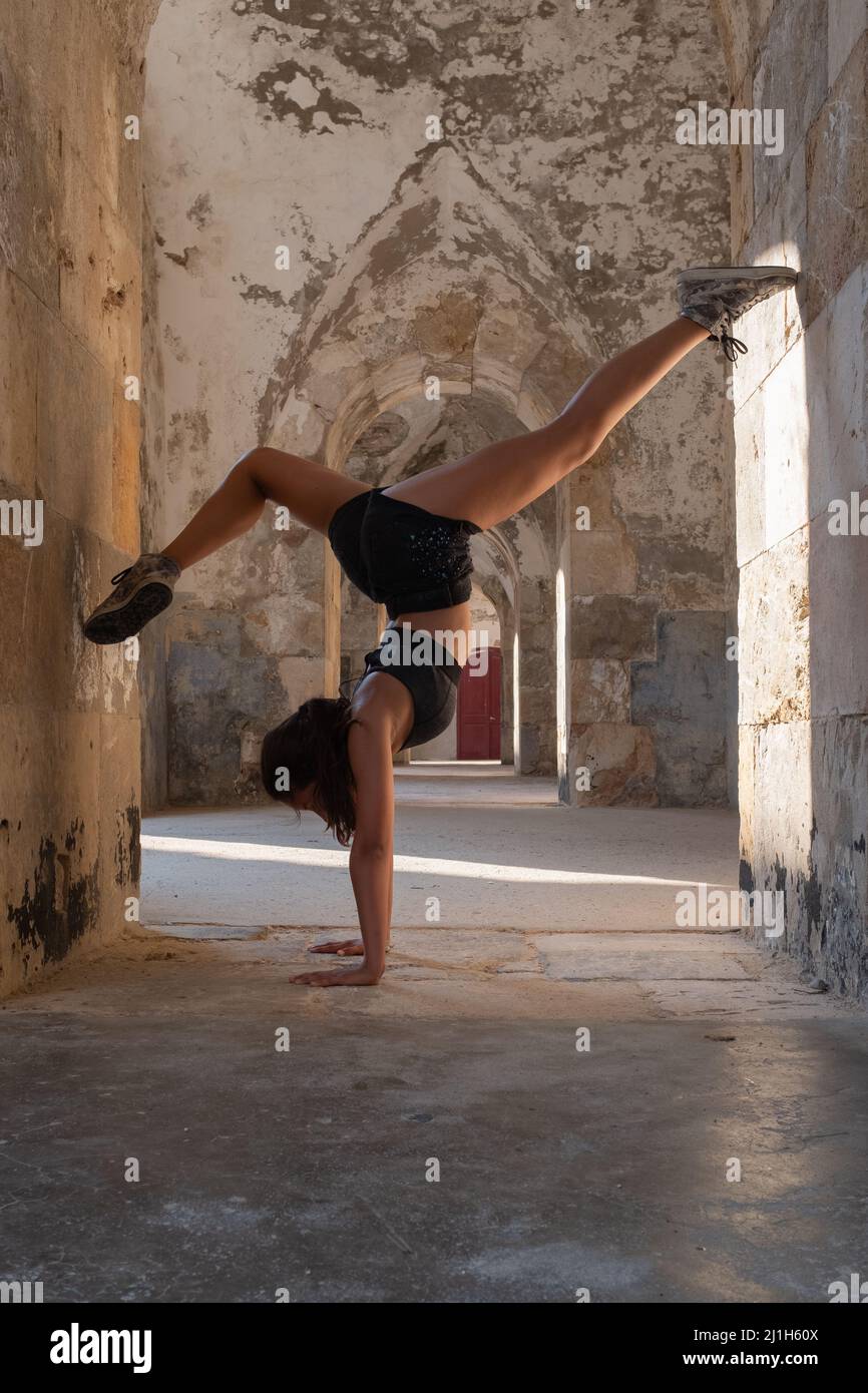 Young woman performs handstands with split legs Stock Photo - Alamy