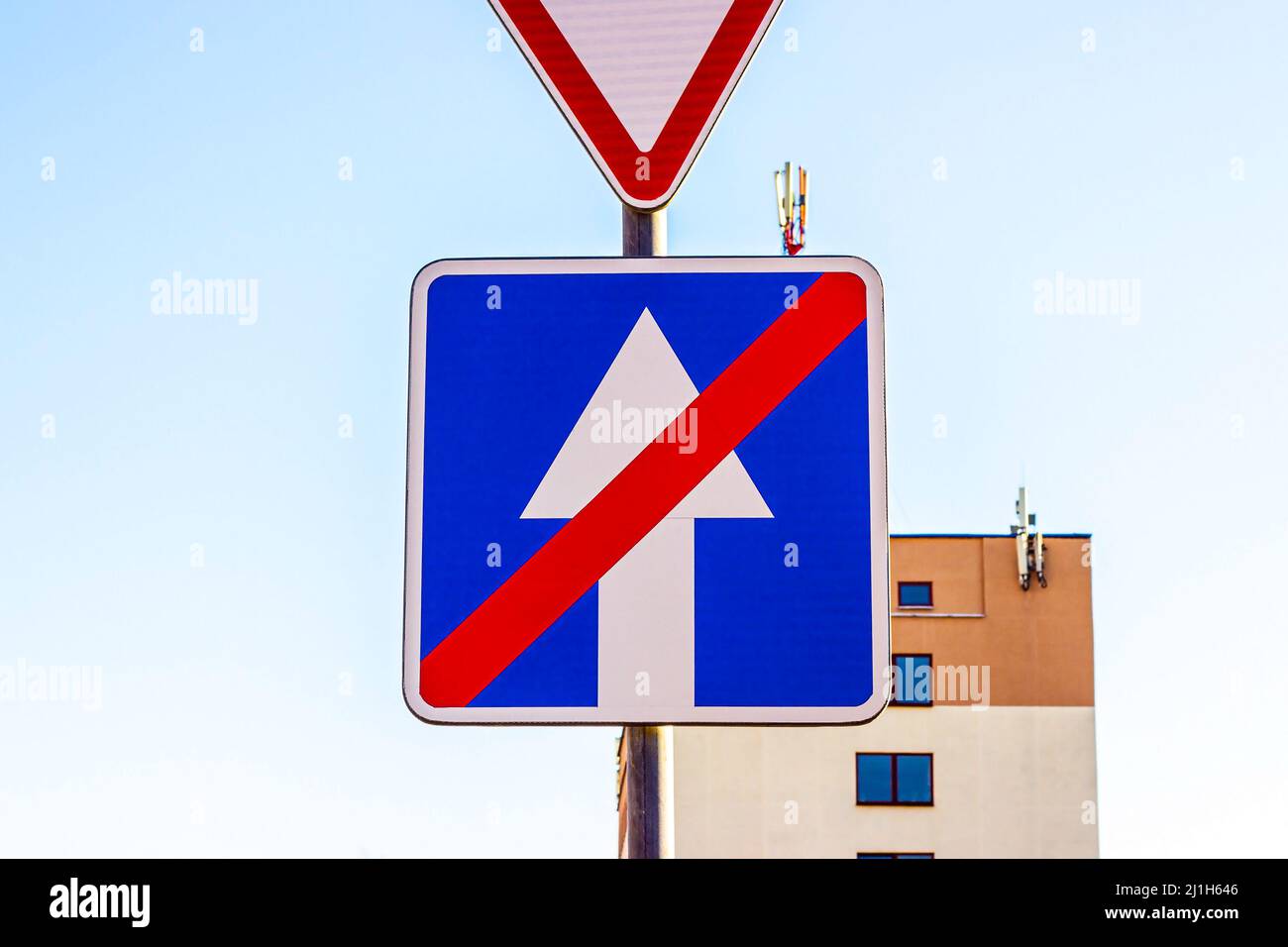 The blue square traffic sign with white crossed arrow the end of a one ...